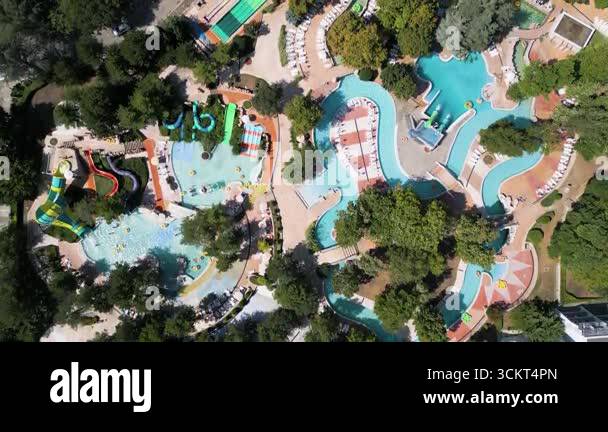 Aerial view of a relaxing water park with interconnected pools, lazy ...