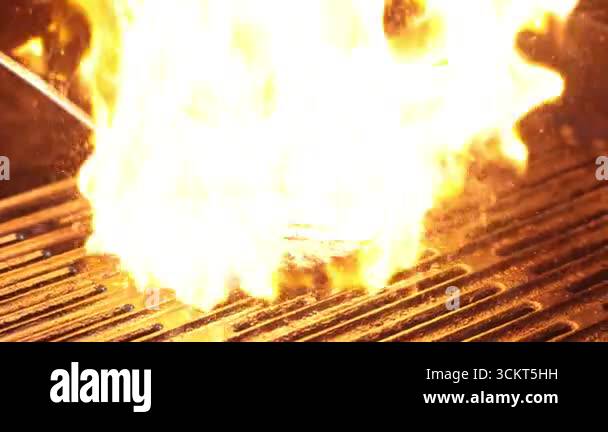 Burger patty catches fire on a grill Stock Video Footage - Alamy