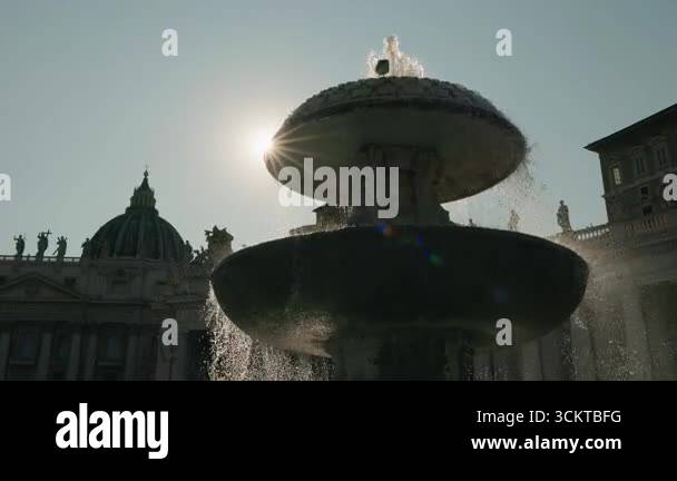 Fountain with splashing water at St. Peters Square with sunlight and ...