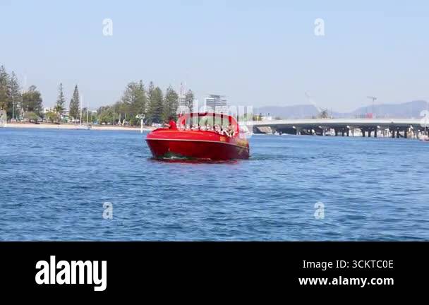 Red jet boat cruising on scenic waterway Stock Video Footage - Alamy