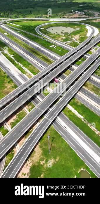 Vertical video aerial view bridge intersection between the highway ...