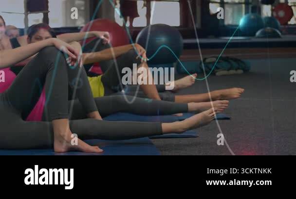 Fitness participants lifting hips into side plank on blue mats following pulsing waveform ...