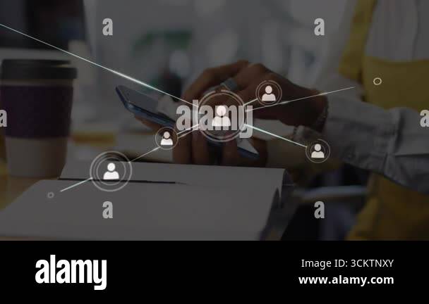 Woman tapping tablet at office desk and building digital network with ...