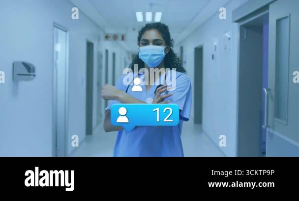 Nurse moving arms in hospital hall activating UI bubble increasing user ...