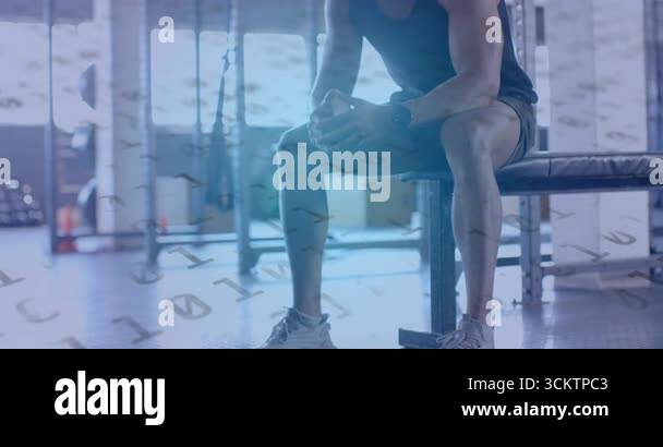 Man entering gym and seating bench, pausing workout and checking ...