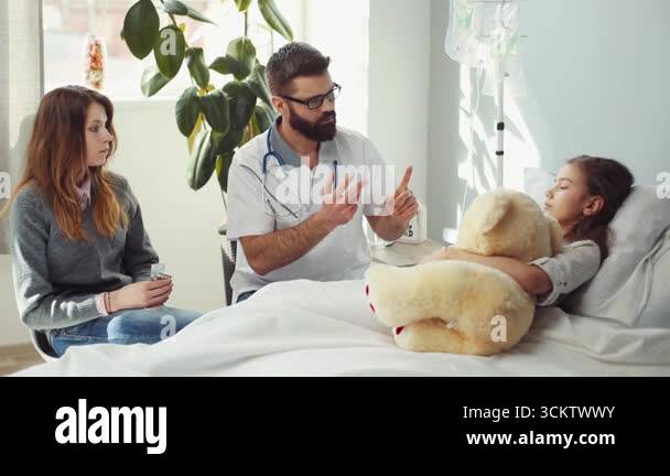 Attractive little sick Ukrainian having on fluids. Physician talking to ...