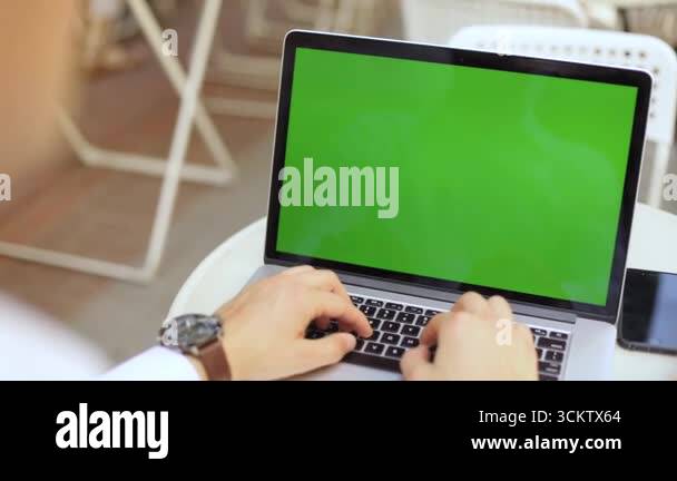 Close up hand man use laptop computer with green screen chroma key ...