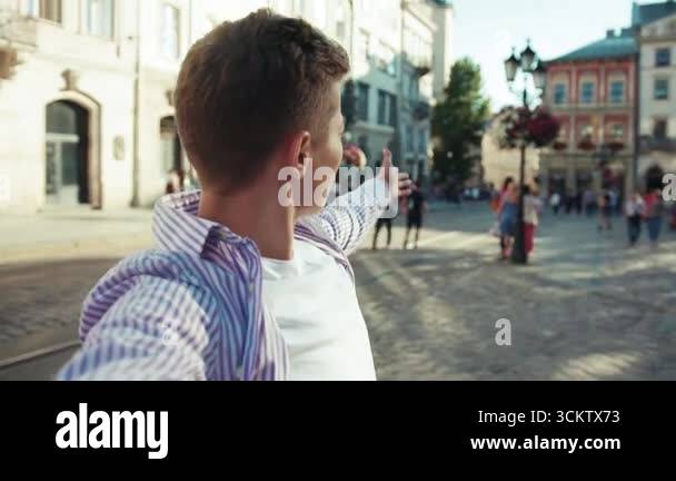 young man look hold camera show around old city smile talk speak on ...