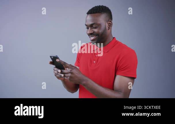 Attractive man in stylish outfit actively texting messages via his ...