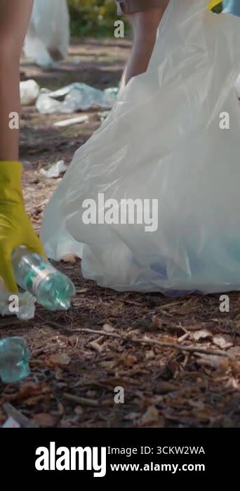 A closeup view showcasing litter such as plastic bottles and wrappers ...