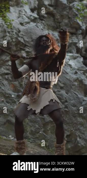 A striking figure stands boldly in rugged terrain, showcasing ancient ...