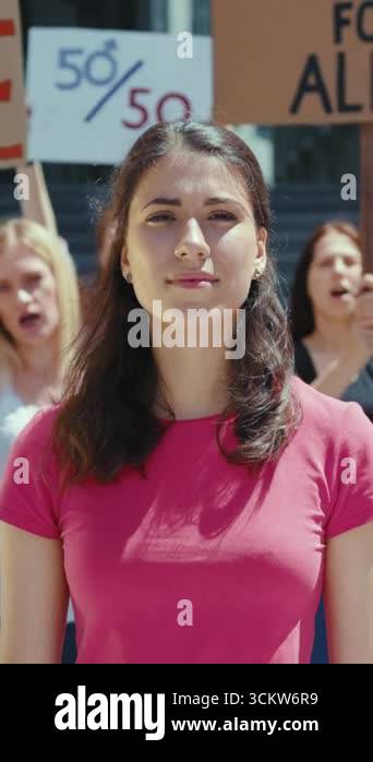A passionate and determined young woman stands boldly in protest for ...