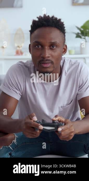 A highly focused and concentrated individual immersed in playing video ...