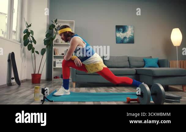 Confident strong retro fitness man doing sports exercise on the mat ...