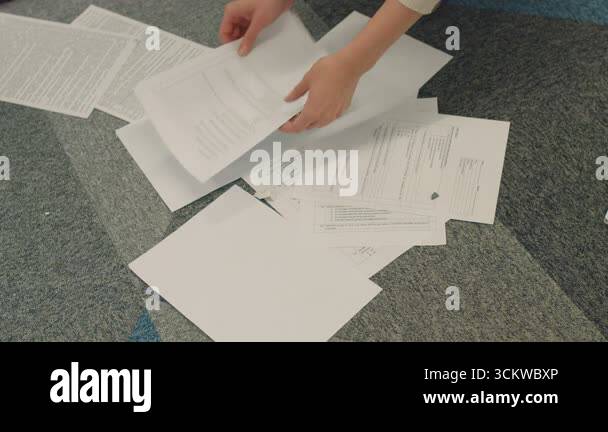 Young girl scattering important documents from floor. Young employee of ...