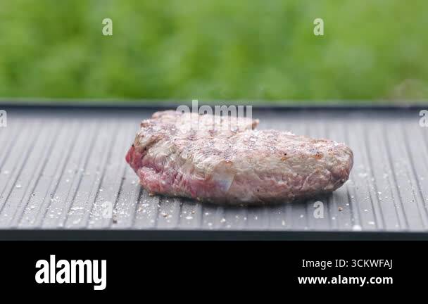 outdoor cooking. cook preparing fresh beef fillet mignon steak with ...
