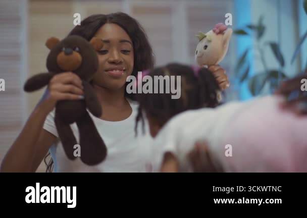Portrait Of Smiling Happy Mother Holding Soft Toys Playing And
