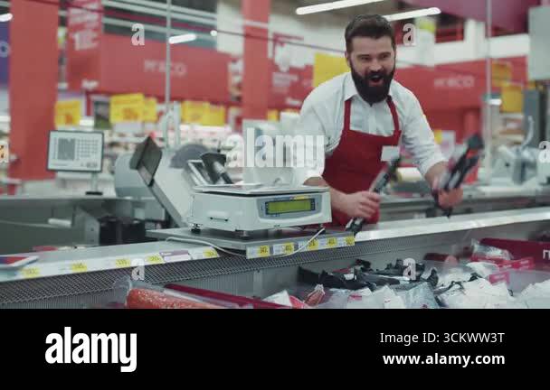 Funny man the seller dances in the meat department in supermarket feel ...