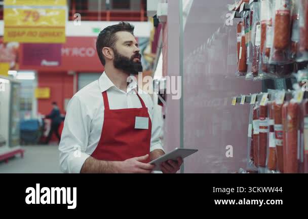 Close up serious seller man with beard use tablet computer in ...