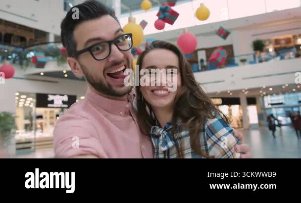 Close up young attractive man looking at shop window with mens suits in ...