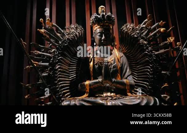 Ornate multi-armed statue sitting against dark background Stock Video ...