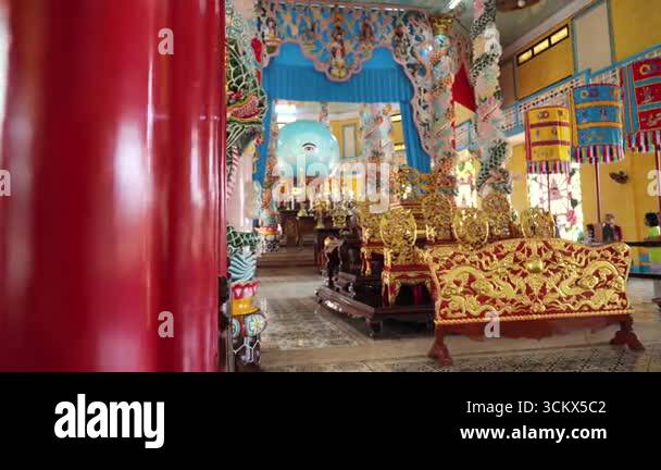 Ornate temple interior featuring colorful decorations and gold carvings ...
