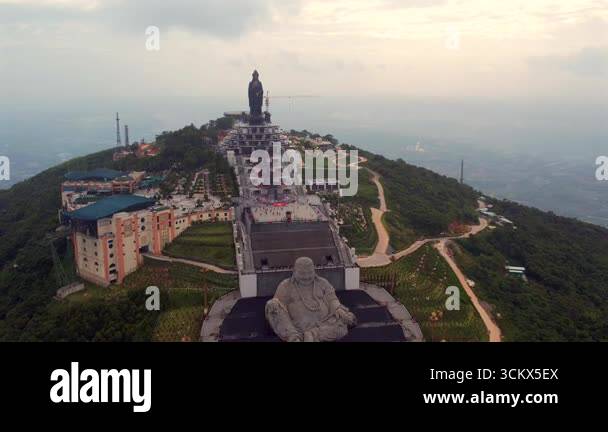 Large buddha statues overlooking green hillside landscape Stock Video ...