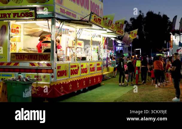 People enjoying food stalls at night fair Stock Video Footage - Alamy