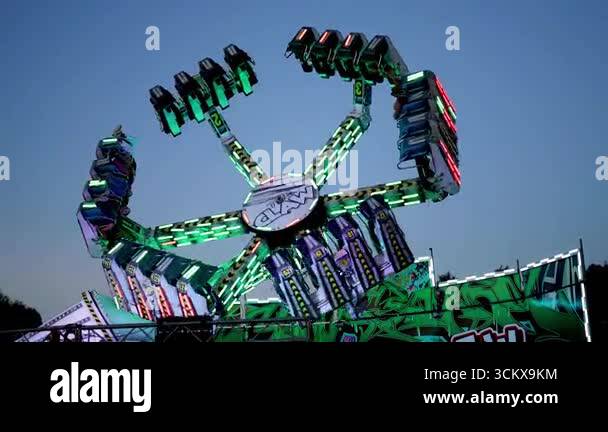 Rotating carnival ride against a clear sky Stock Video Footage - Alamy