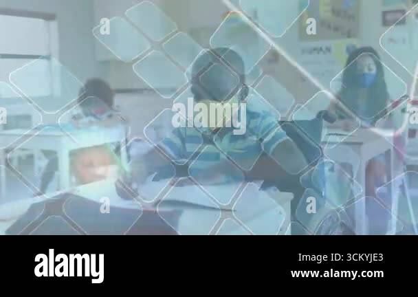 Boy lowering pencil and writing in education classroom while ...