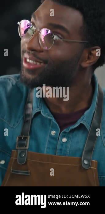 African American man working roasted coffee beans using industrial roasting machine male roaster ...