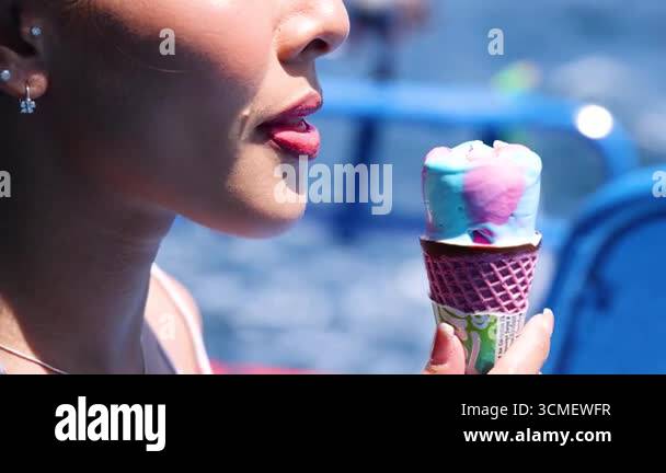 Asian woman licking amazing ice-cream Stock Video Footage - Alamy
