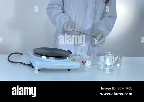 Scientist demonstrates sodium acetate crystallization process Stock ...