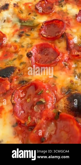 A closeup of a delicious pepperoni pizza with fresh toppings and a ...