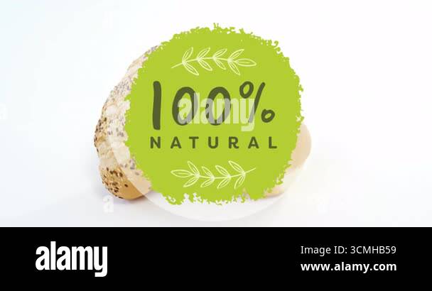 Animation of 100 percent natural against close up of a fresh bread on ...