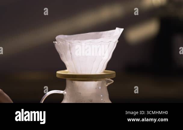 Hand drip coffee. Barista pouring brew coffee ground into filter ...