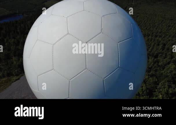 A close-up aerial view of the hexagonal sphere of a weather radar tower ...