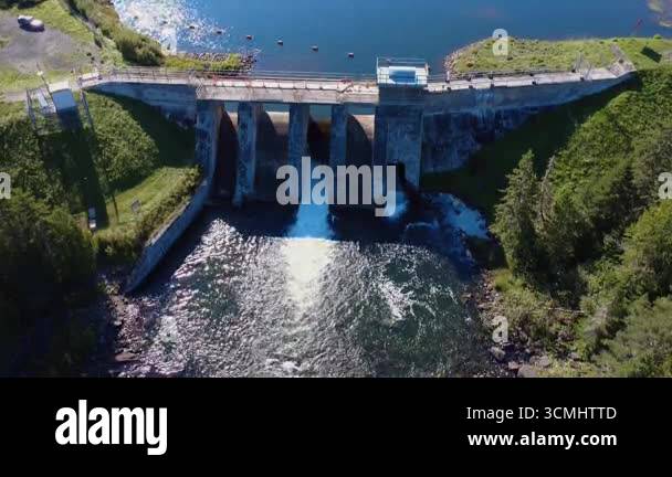 Aerial view of an old concrete hydroelectric dam discharging its ...