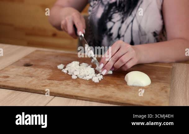 The onion is cut into small pieces with a knife Stock Video Footage - Alamy