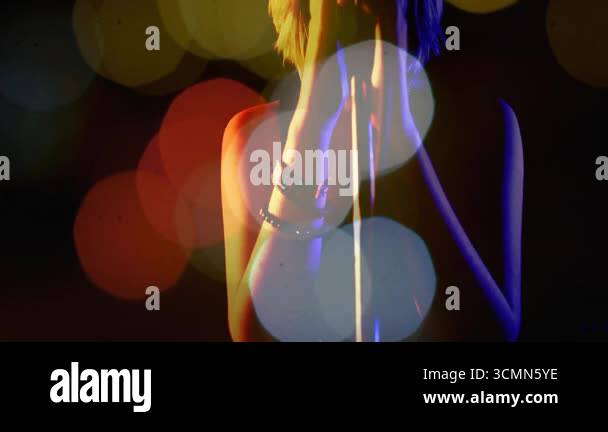 Teenage singer touching and cradling mic while facing camera ...