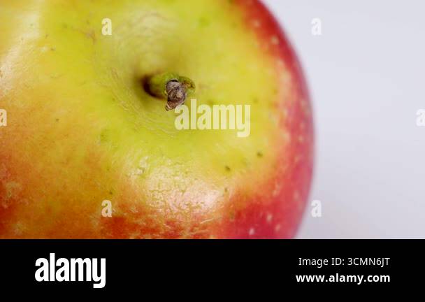 Macro video of a rotating apple with vibrant red and green hues ...