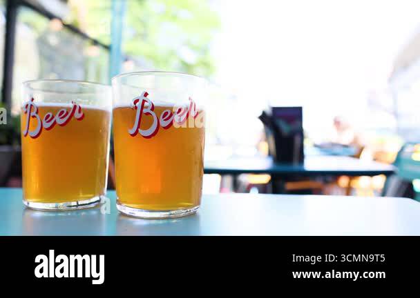 Two pints of beer on a table Stock Video Footage - Alamy