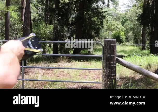 Sequence of a slingshot firing a projectile outdoors Stock Video ...