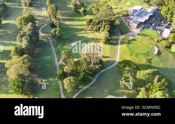 Drone captures expansive golf course with lush greenery, clubhouse, and ...