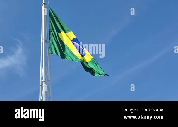 Video of a Brazilian flag fluttering in the wind on a blue sky day ...