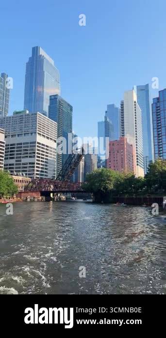 Vertical perspective of Chicago River with downtown bridges and tall ...