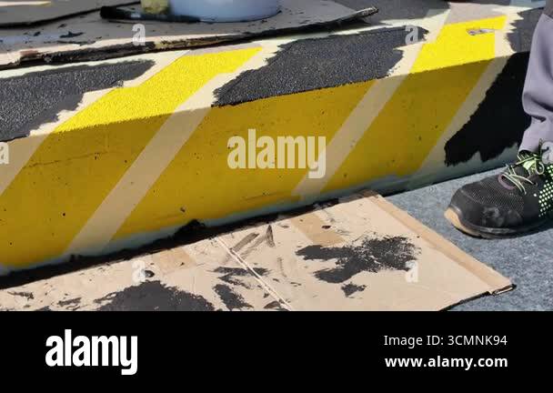 Coating safety stripes on railway platforms. Coating railway platforms ...