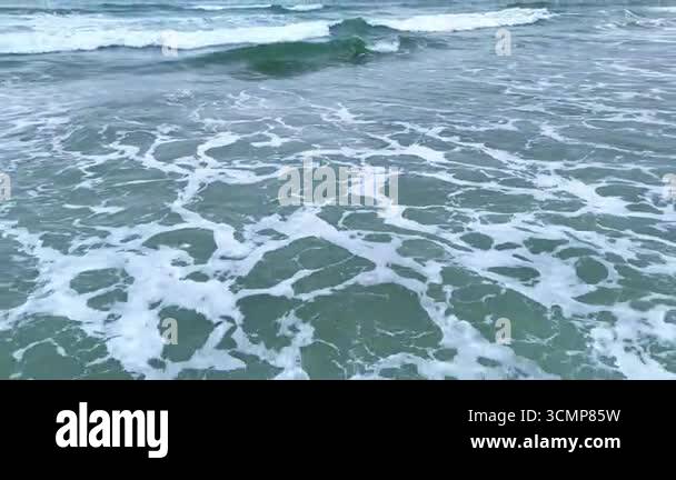 Aerial drone closeup of ocean waves with white foam on the surface ...