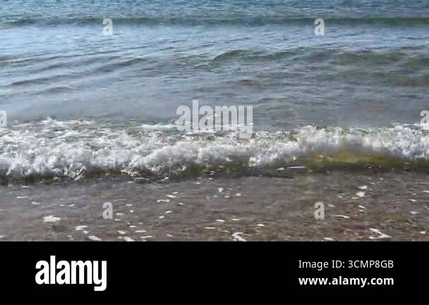 Small ocean waves breaking on sandy shore. High quality 4k footage ...