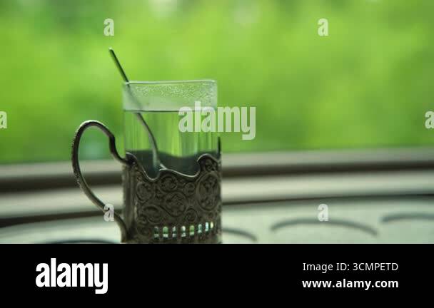 Green tea in a glass on a table in a moving train. High quality 4k ...